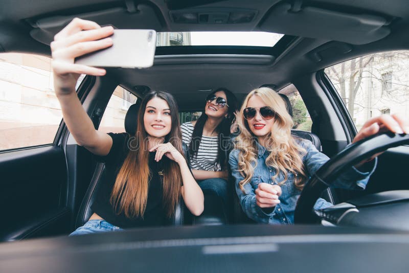 Group of Girls Having Fun in the Car and Taking Selfies with Camera ...