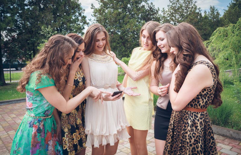 Group of Girls Looking at a Cell Phone Stock Photo - Image of gossiping ...