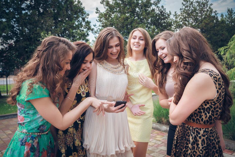 Group of Girls Looking at a Cell Phone Stock Photo - Image of adults ...