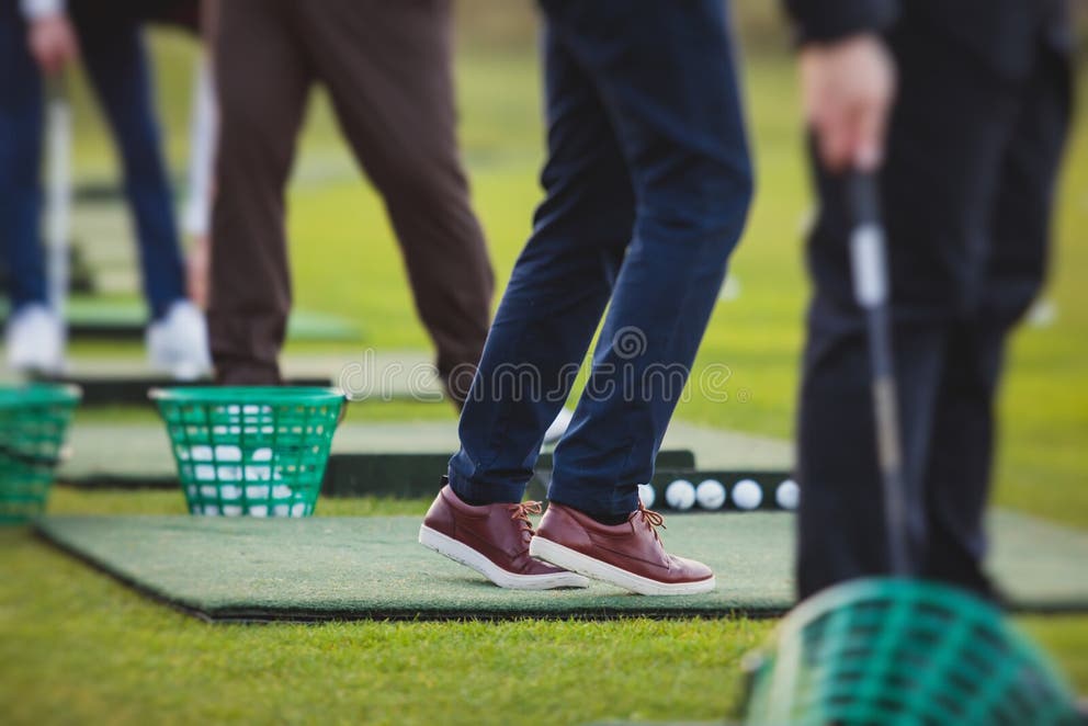 Group of Golfers Practicing and Training Golf Swing on Driving Range ...