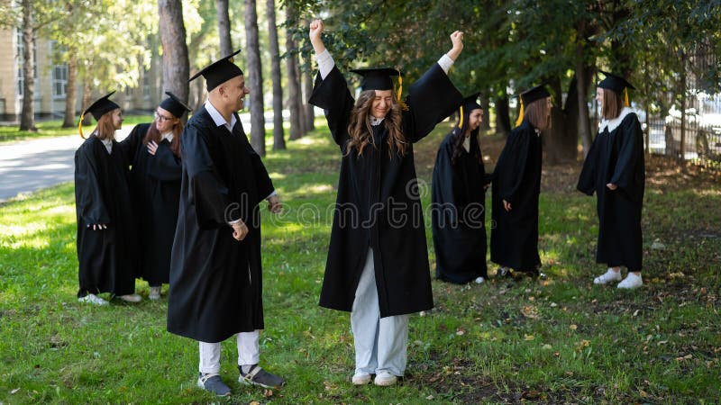 A Group of Graduates in Robes Congratulate Each Other on Their ...