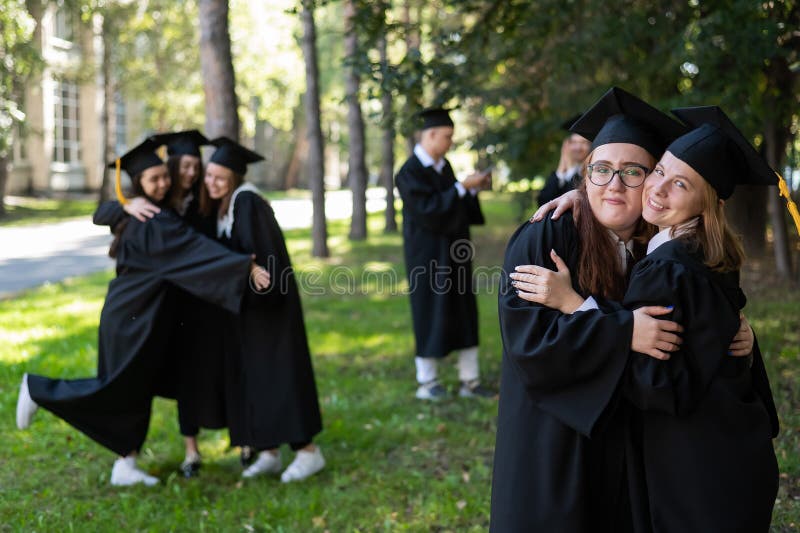 A Group of Graduates in Robes Congratulate Each Other on Their ...