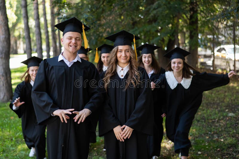 A Group of Graduates in Robes Congratulate Each Other on Their ...