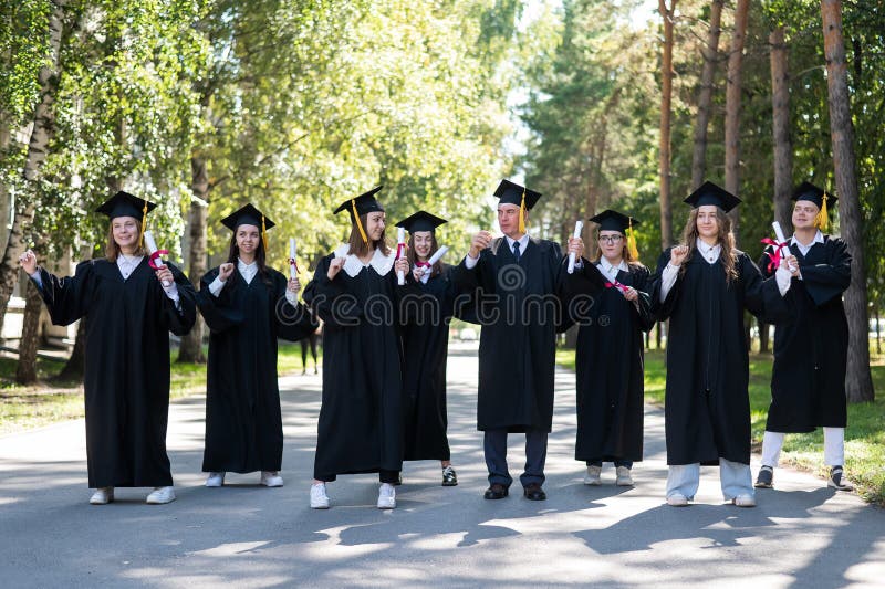 A Group of Graduates in Robes Outdoors. an Elderly Man and a Young ...