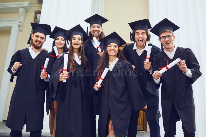 A Group of Graduates Smiling Stock Photo - Image of outdoors, education ...