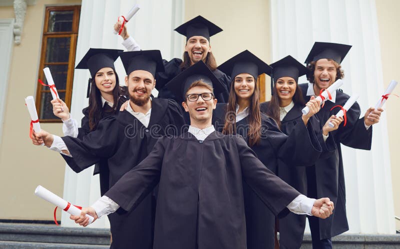 A Group of Graduates Smiling Stock Image - Image of outdoors, scroll ...