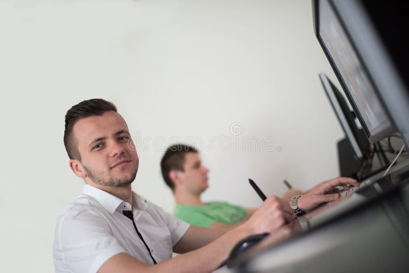 A Group of Graphic Designers at Work Stock Photo - Image of notebook ...