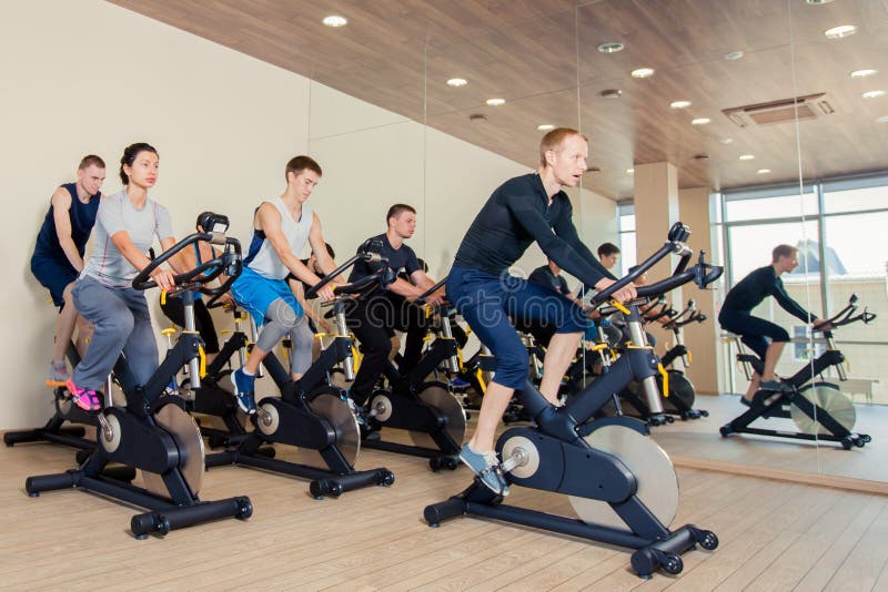 Group of Gym People on Machines, Cycling in Class Stock Photo - Image ...