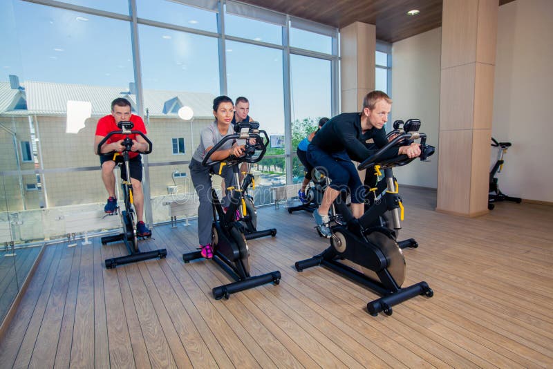Group of Gym People on Machines, Cycling in Class Stock Photo - Image ...