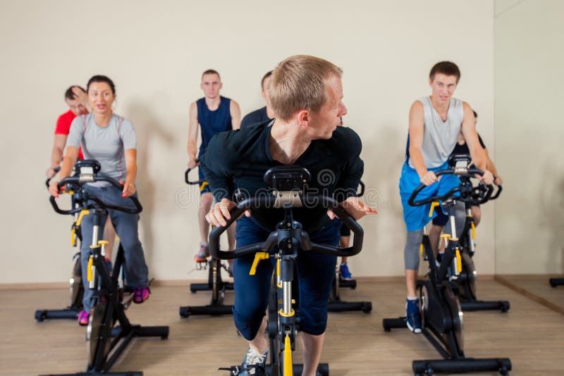 Group of Gym People on Machines, Cycling in Class Stock Photo - Image ...