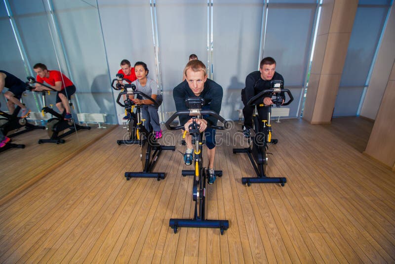 Group of Gym People on Machines, Cycling in Class Stock Photo - Image ...