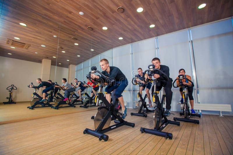 Group of Gym People on Machines, Cycling in Class Stock Photo - Image ...