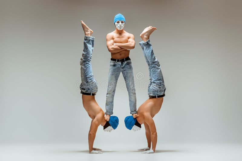 The Group of Gymnastic Acrobatic Caucasian Men on Balance Pose Stock ...