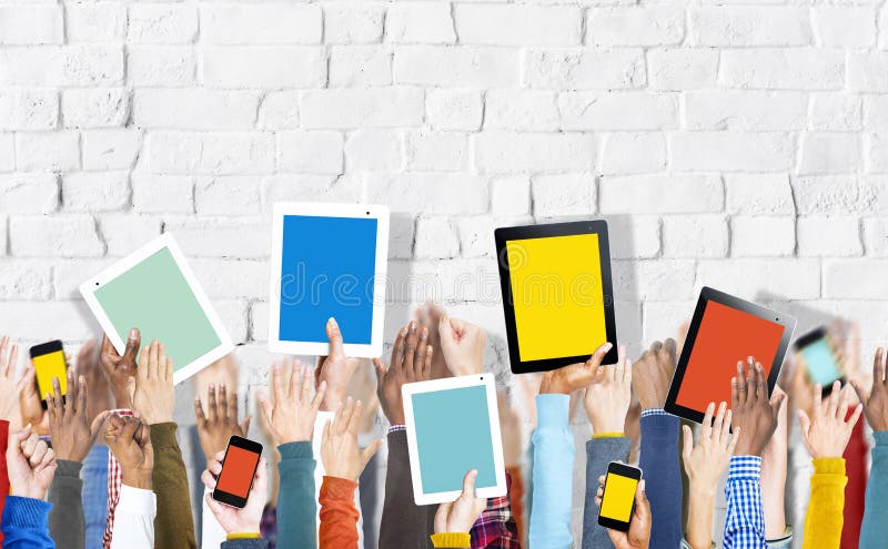 Group of Hands Holding Digital Devices on Brick Wall Stock Photo ...