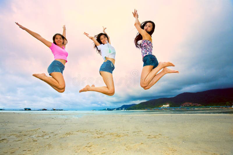 Group of Friends Jumping into the Sea Stock Photo - Image of attractive ...
