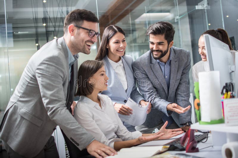 Group of Happy Cheerful Businesspeople Working Around Computer during ...