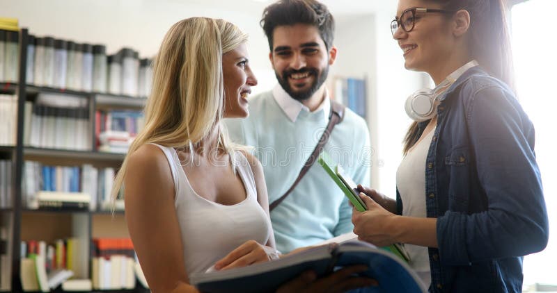 Group of Happy College Students Studying at Campus Library Together ...