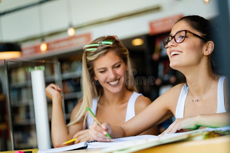 Group of Happy College Students Studying at Campus Library Together ...