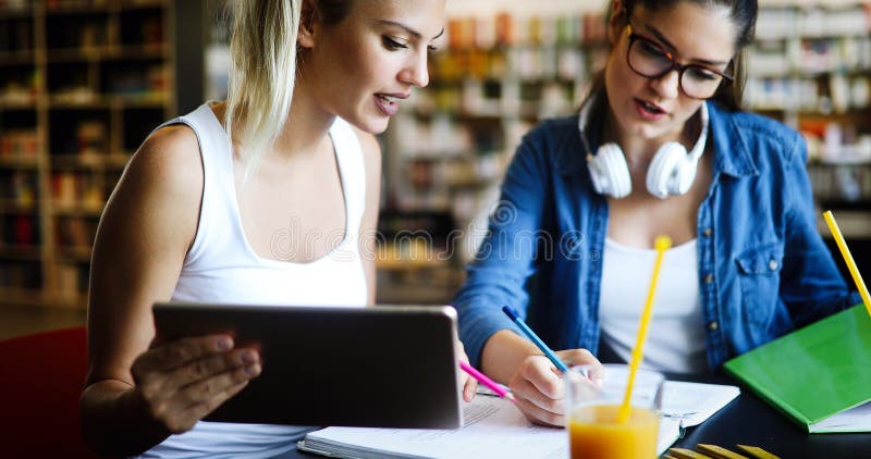 Group of Happy College Students Studying at Campus Library Together ...
