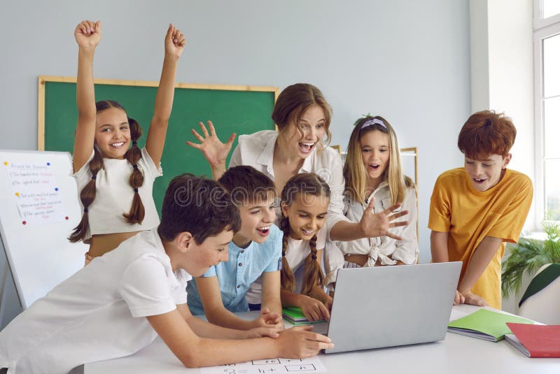 Group of Happy Excited School Children and Teacher Using Laptop and ... Group of Happy Excited School Children and Teacher Using Laptop and ...