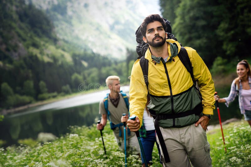 Group of Happy Friends with Backpacks Hiking Together Stock Photo ...