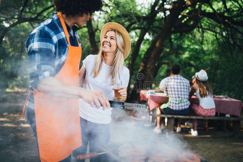 Group of Happy Friends Eating and Drinking Beers at Barbecue Dinner ...