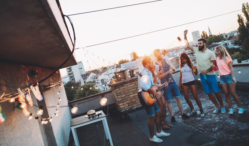 Group of Happy Friends Having Party on Rooftop Stock Image - Image of ...
