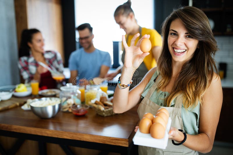 Group of Happy Friends Laughing and Talking while Preparing Meals in ...