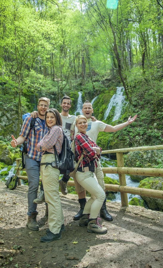 Group of Happy Friends Posing in Nature in Front of a Waterfall Stock ...