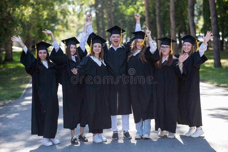 A Group of Graduates in Robes Outdoors. an Elderly Man and a Young ...