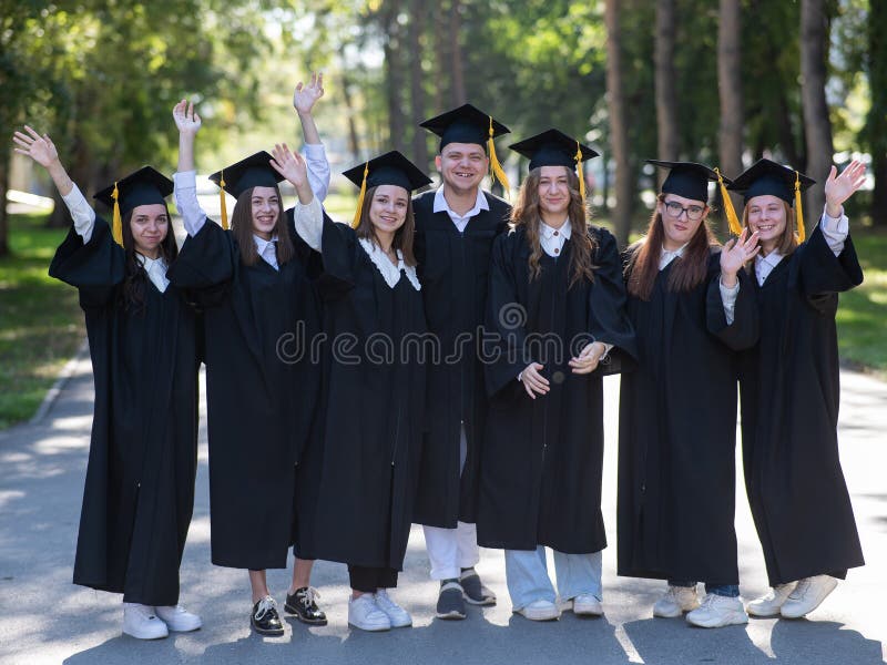 Group of Happy Graduates in Robes Outdoors. Stock Image - Image of ...