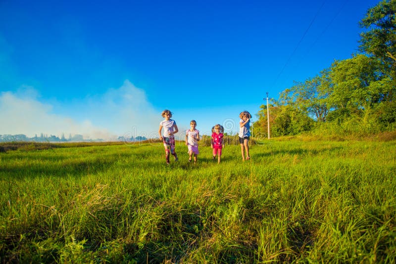 Group of Happy Kids Running in Summer Field Stock Photo - Image of fast ...
