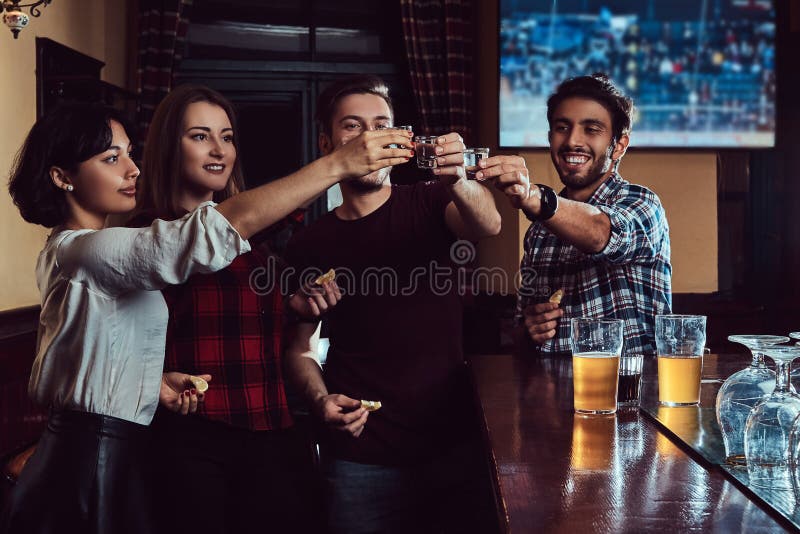 Group of Happy Multiracial Friends Making a Toast with Vodka while ...