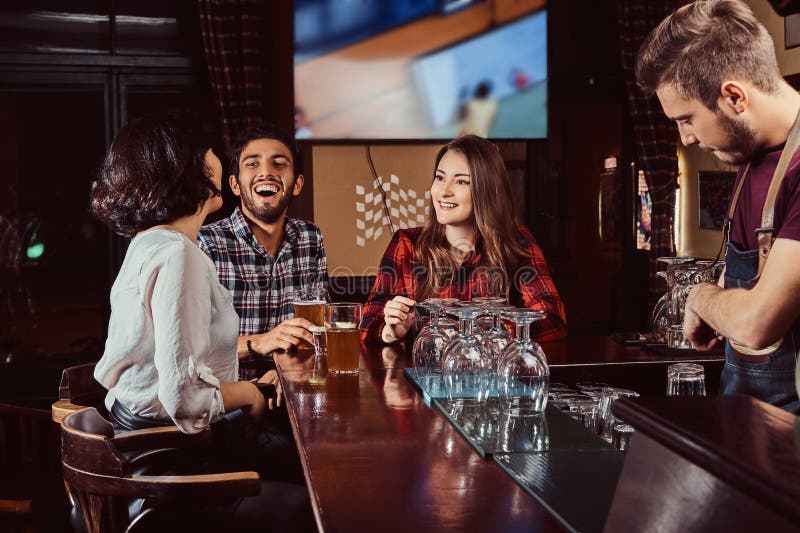 Group of Happy Multiracial Friends Resting and Talking at Bar or Pub ...