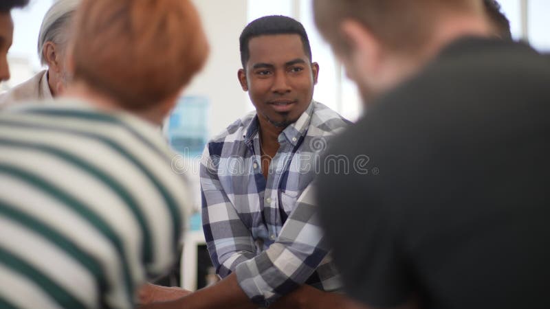 Group of Happy Multiracial People Holding Hands Sitting in Circle ...