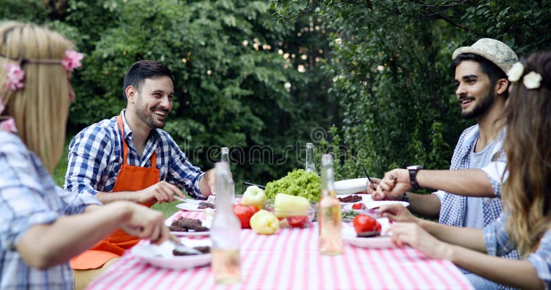 Group of Happy People Eating Food Outdoors Stock Photo - Image of male ...