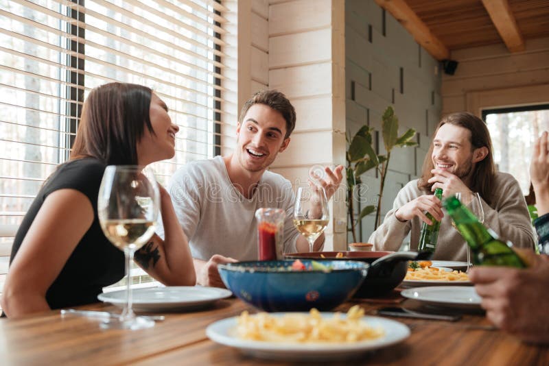 Group of Happy People Eating and Talking at the Table Stock Image ...