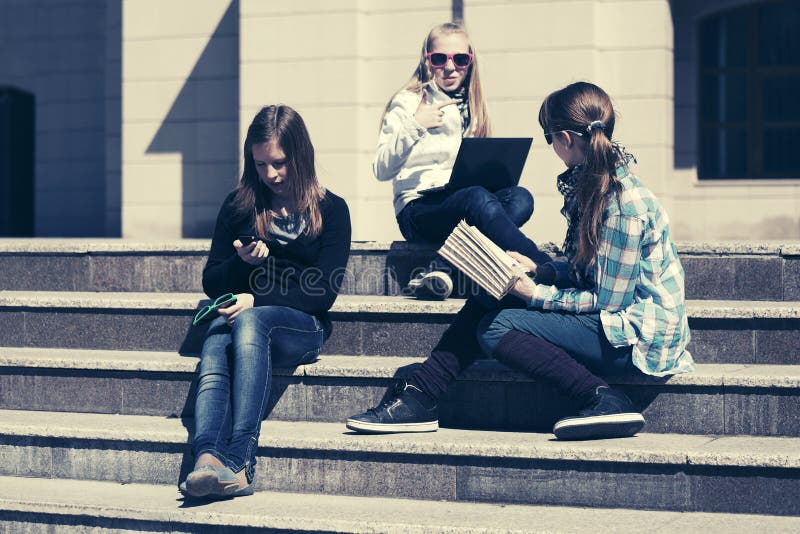 Group of Happy School Girls Sitting on Steps Stock Photo - Image of ...