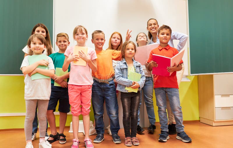 Happy School Kids Posing with Teacher in Class Stock Image - Image of ...