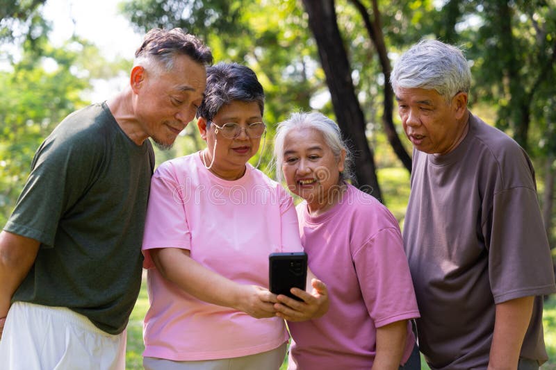 Group of Happy Senior Retirement Using Smartphone and Laughing Outdoors ...