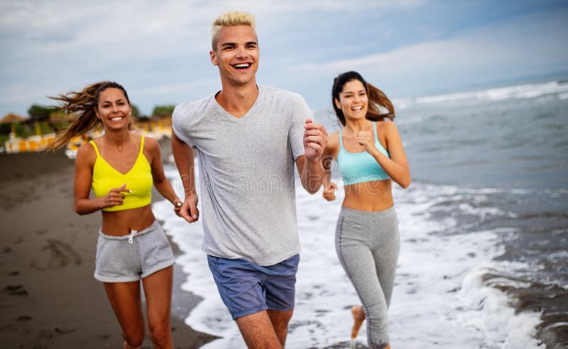 Group of Sport People Jogging on the Beach Stock Photo - Image of ...