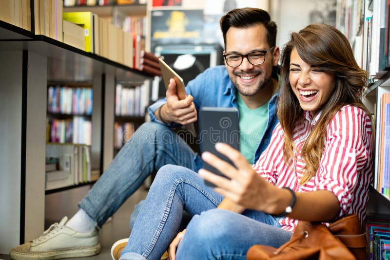 Group of Happy Students Reading Books and Preparing To Exam in Library ...
