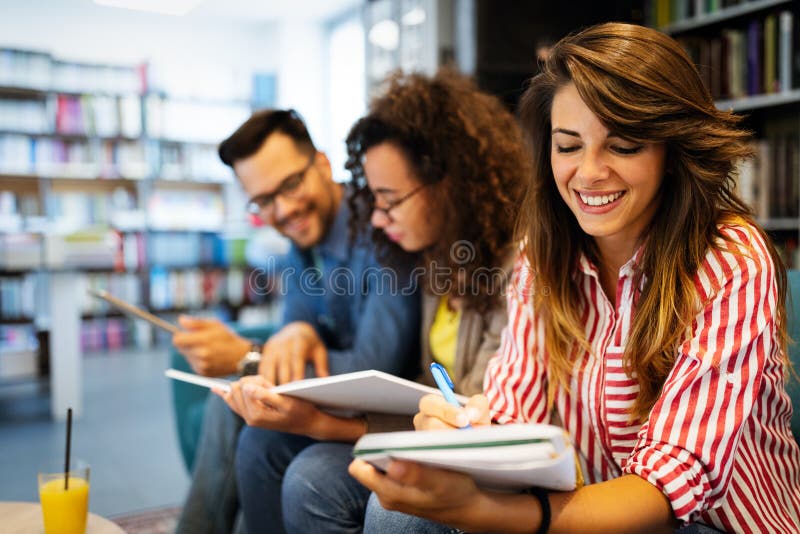 Group of Happy Students Reading Books and Preparing To Exam in Library ...