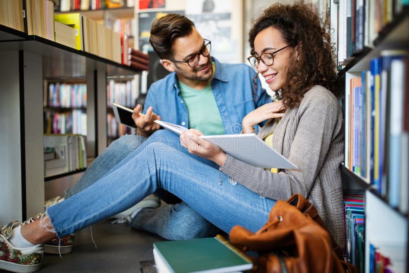 Group of Happy Students Reading Books and Preparing To Exam in Library ...