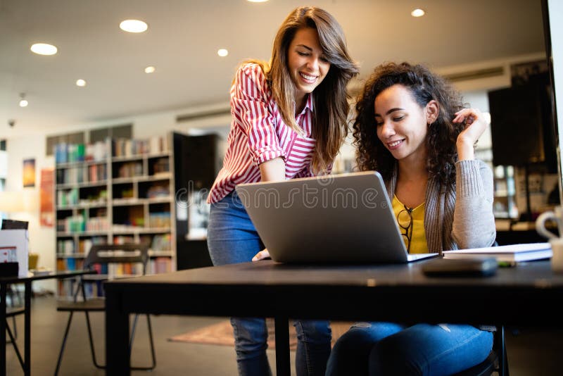 Group of Happy Students Reading Books and Preparing To Exam in Library ...