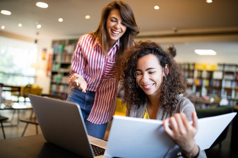 Group of Happy Students Reading Books and Preparing To Exam in Library ...