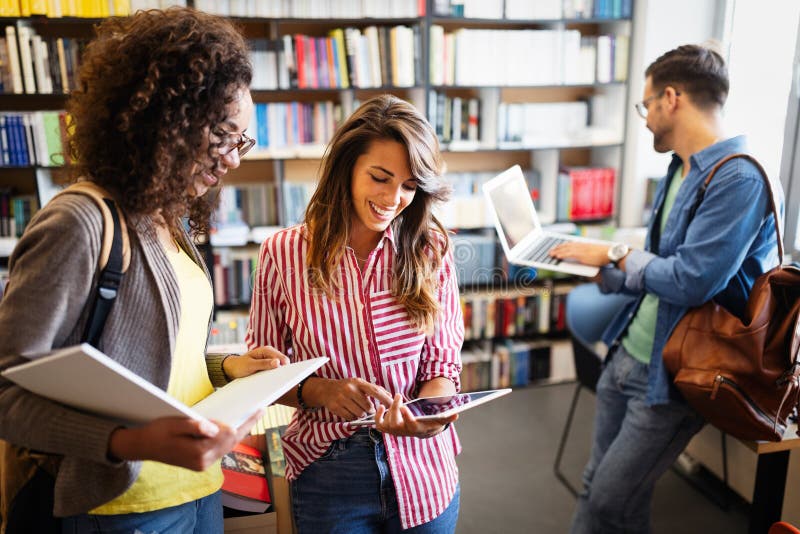 Group of Happy Students Reading Books and Preparing To Exam in Library ...