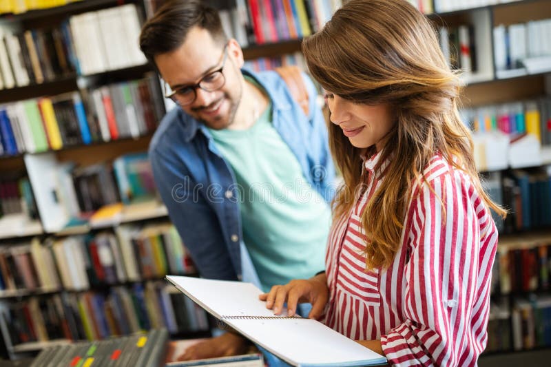 Group of Happy Students Reading Books and Preparing To Exam in Library ...