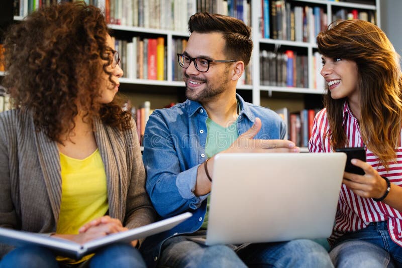 Group of Happy Students Reading Books and Preparing To Exam in Library ...