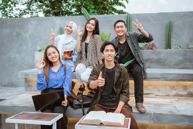 Group of Happy Students Smiling with Some Hand Gestures while Sitting ...